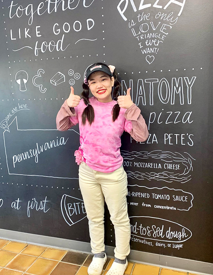 The wall of pizza wisdom speaks truth: "Pizza is the only love triangle I ever want." Truer words were never written in chalk.