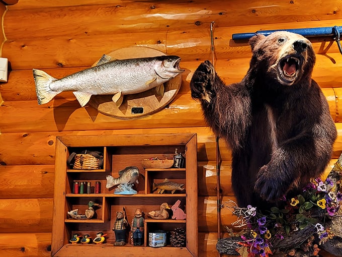 The taxidermy bear stands guard over fishing memorabilia, embodying the playful wilderness spirit that defines the Big Bear experience.