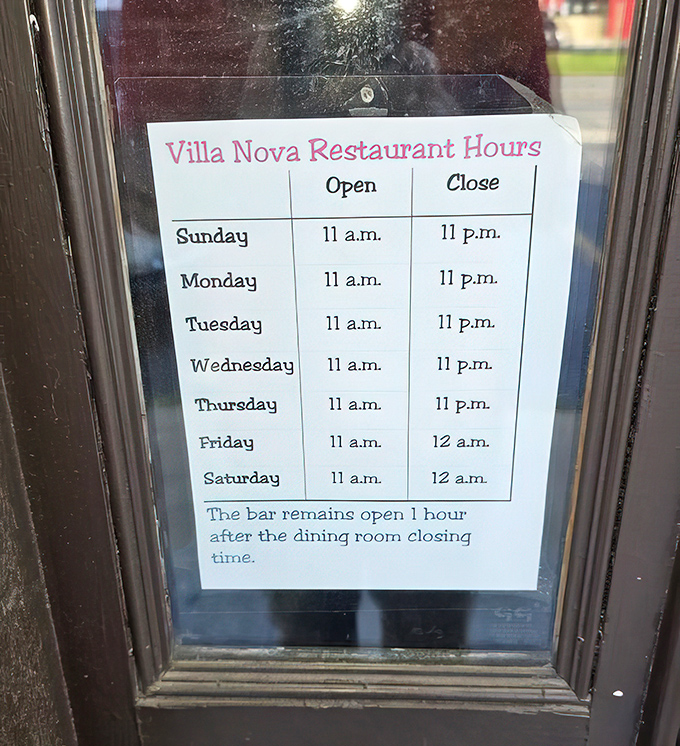 Restaurant hours posted like a promise&mdash;open seven days a week. The bar stays open later because good conversations deserve extra time.