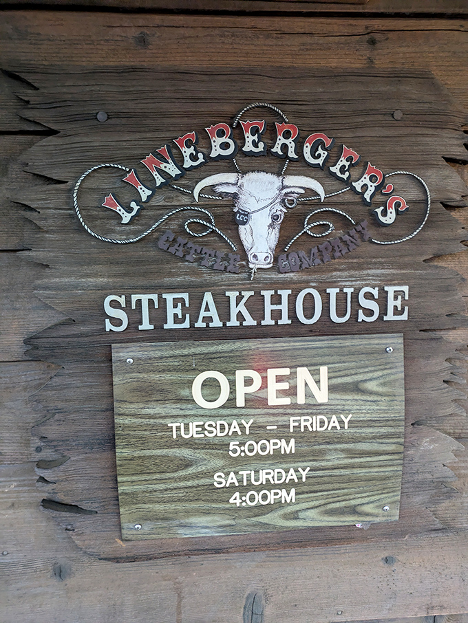 Operating hours posted on weathered wood &ndash; information that's worth committing to memory if you value exceptional beef.