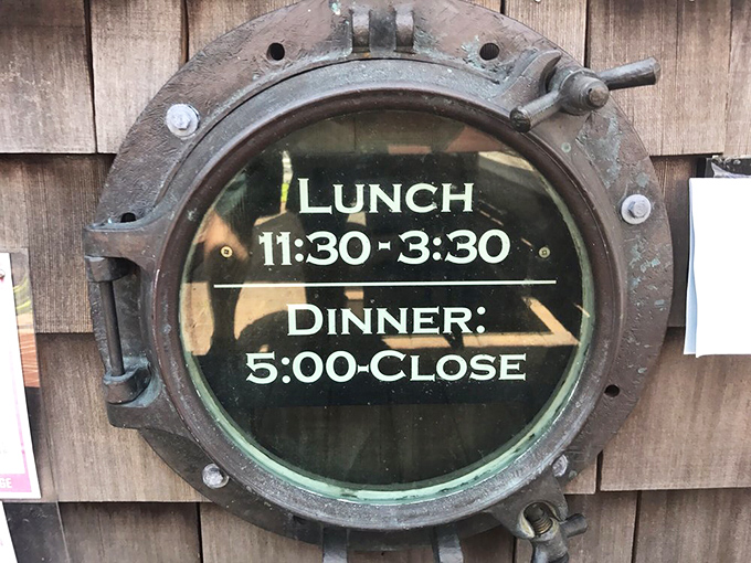 Even the hours sign embraces the nautical theme&mdash;a porthole window to plan your dining schedule around that crab bisque craving.