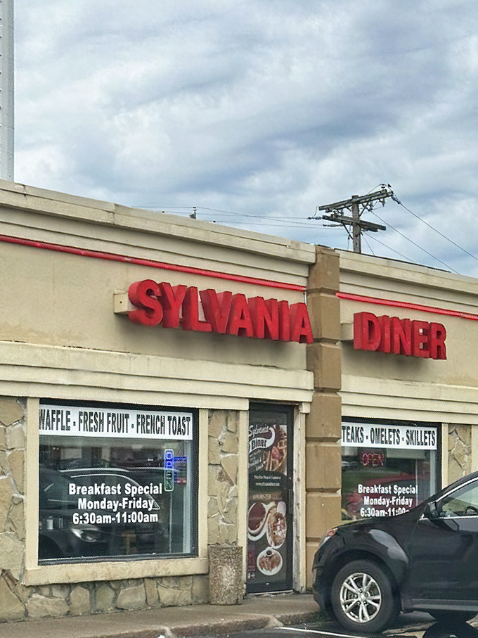 Daytime reveals the diner's unassuming charm. Those stone accents and breakfast promises are the architectural equivalent of comfort food.