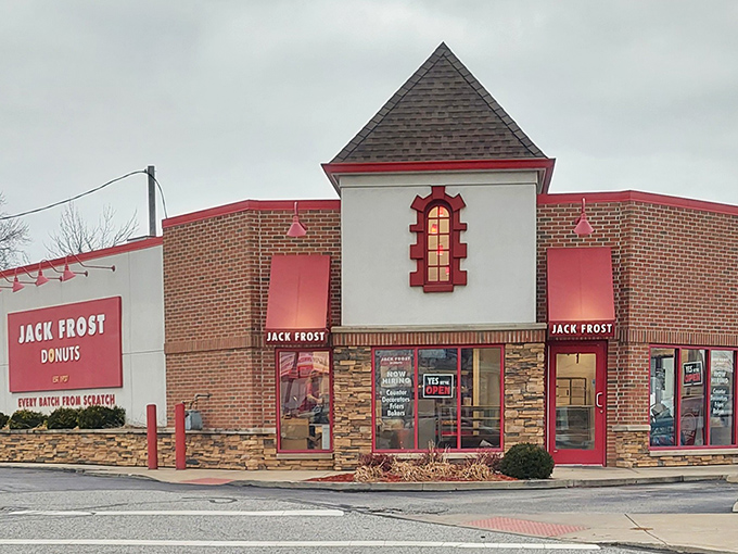 The charming storefront with its distinctive red trim and stone accents looks like it belongs in a fairy tale about magical pastries.