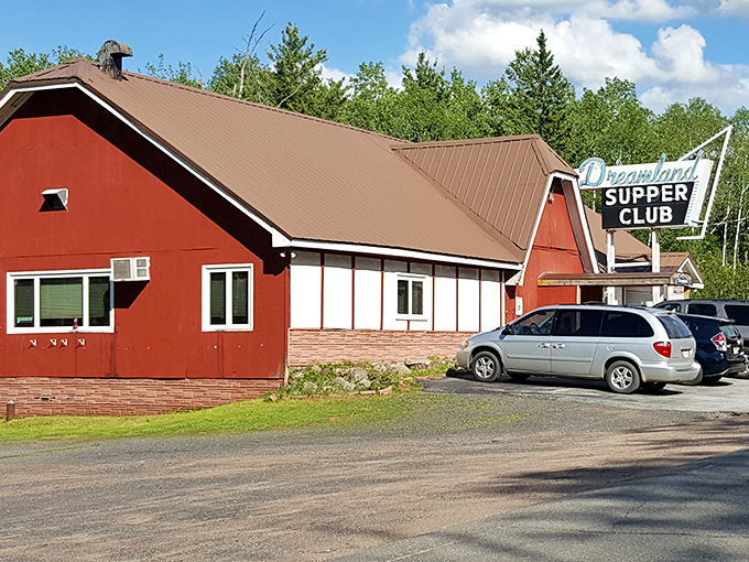 The daytime view reveals Dreamland's barn-red exterior&mdash;standing proud against the northwoods backdrop like a beacon for hungry travelers.