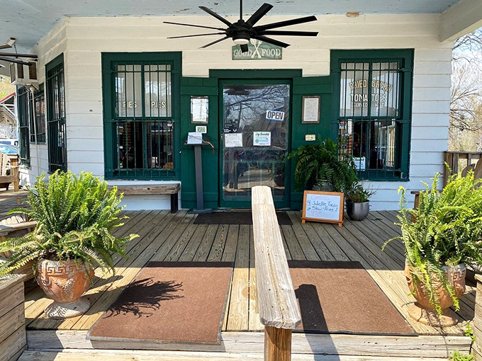 The green door beckons like a portal to flavor country, with potted ferns standing guard over this temple of Southern cuisine.