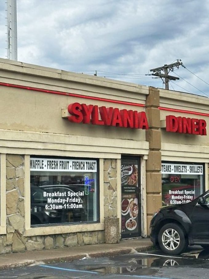 Rain-slicked pavement reflects the iconic red signage&mdash;a beacon of comfort food hope on a gray Ohio day.