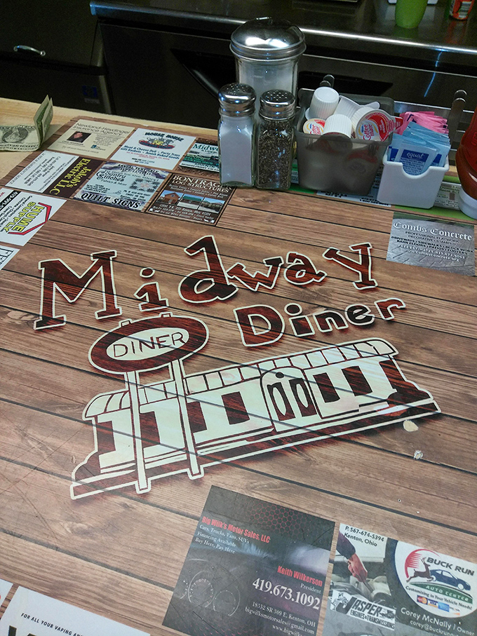 The table setting tells the whole story: salt, pepper, sugar packets, and local business cards&mdash;the essential elements of diner ecosystem.