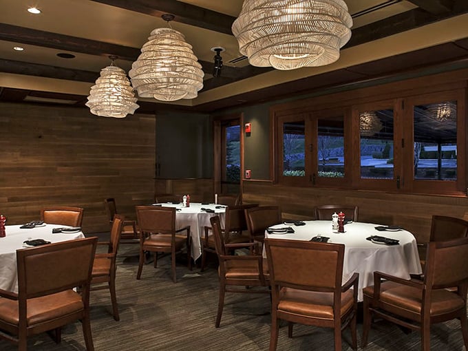 Elegant simplicity defines the dining room, where woven pendant lights cast the kind of glow that makes everyone look like they've just returned from vacation.
