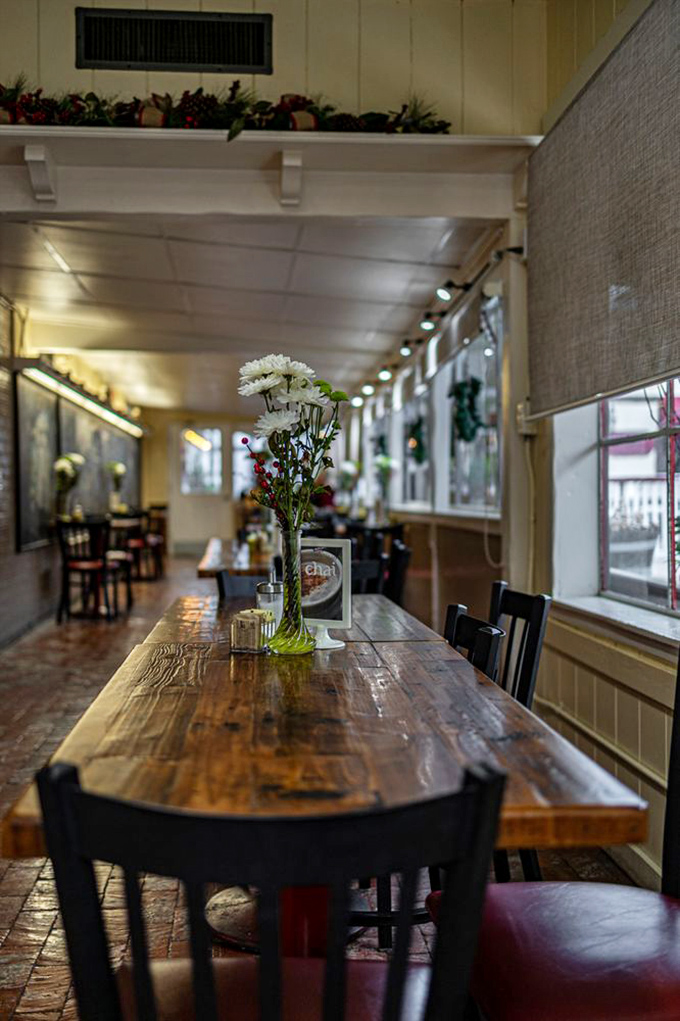 A rustic wooden table bathed in natural light, where strangers become friends over shared pastry recommendations and coffee refills.