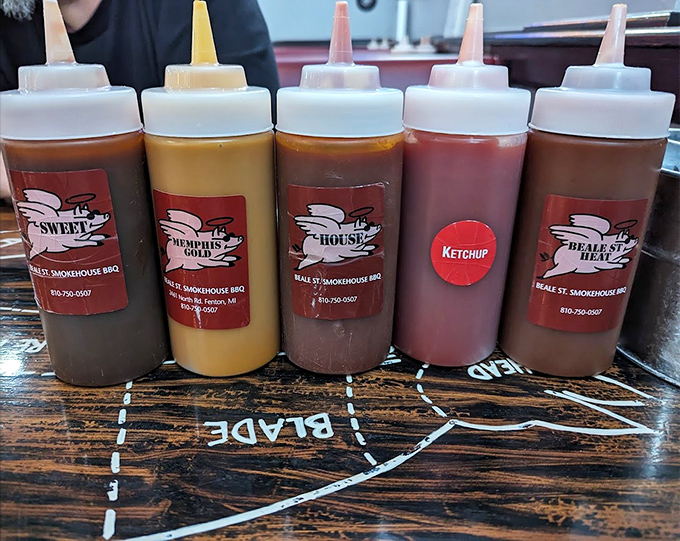 Five signature sauces stand ready like barbecue soldiers, each one offering a different path to smoky, saucy enlightenment.