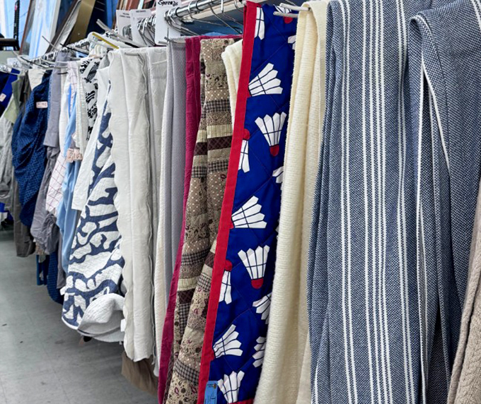 Textile treasures hanging like art. That blue fabric with badminton shuttlecocks is the conversation starter your guest room has been waiting for.