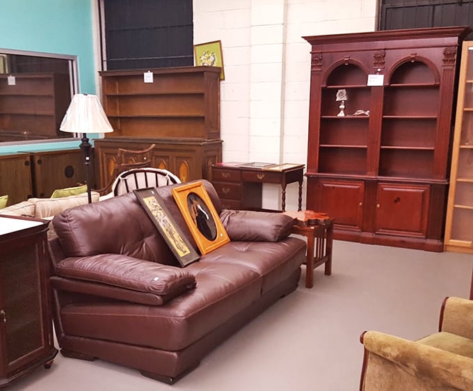 Rich wood tones and burgundy leather create a sophisticated furniture vignette that could transform a first apartment from college-dorm-adjacent to grown-up-chic.