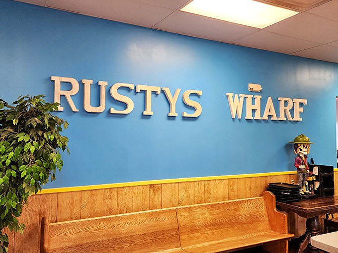 The blue wall proudly displays the Rusty's Wharf name, while a wooden bench invites you to take a seat if there's a wait&mdash;there often is.