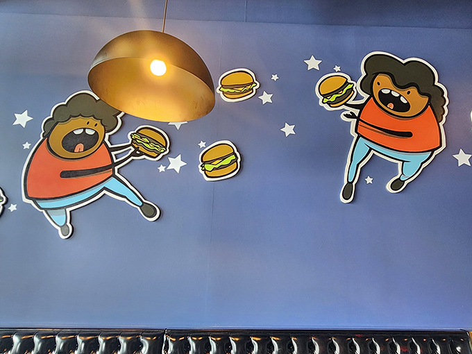 These whimsical burger-loving characters on the wall perfectly capture how you'll feel after your first bite &ndash; floating in a state of burger euphoria.