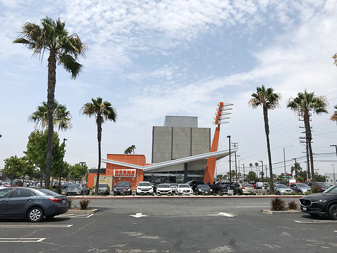 Palm trees frame the restaurant like nature's exclamation points, saying "Stop here! Deliciousness awaits!" in true California style.