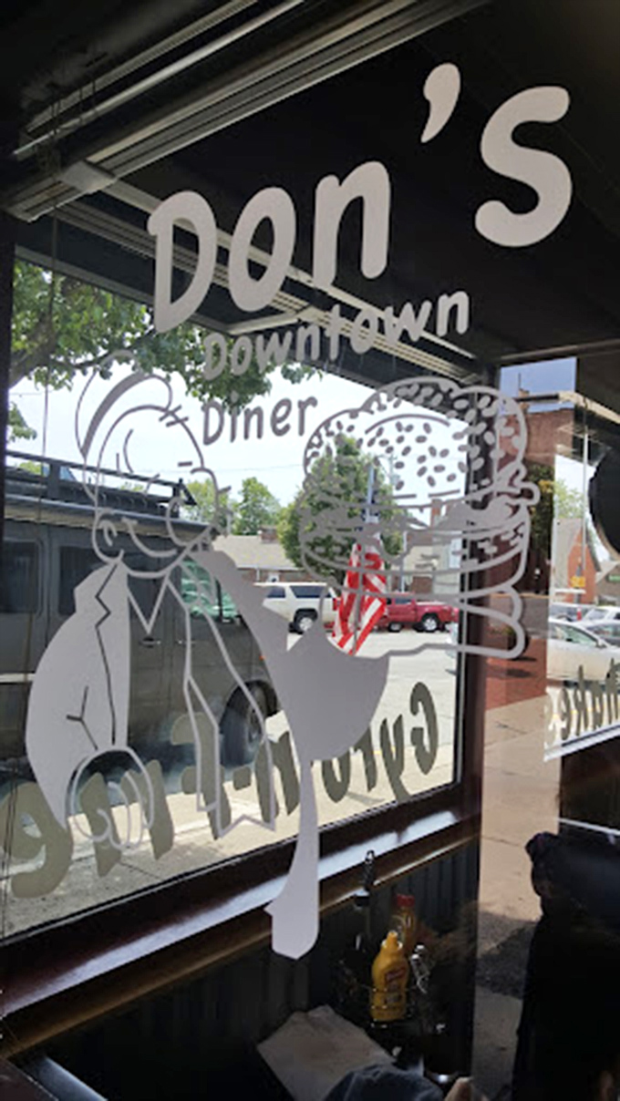 The window beckons hungry travelers with promises of legendary burgers and hometown hospitality.