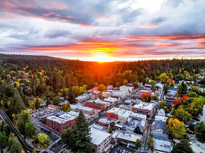 Sunset paints Nevada City in golden light, nestled perfectly among towering pines. From above, you see how nature and town exist in rare harmony.