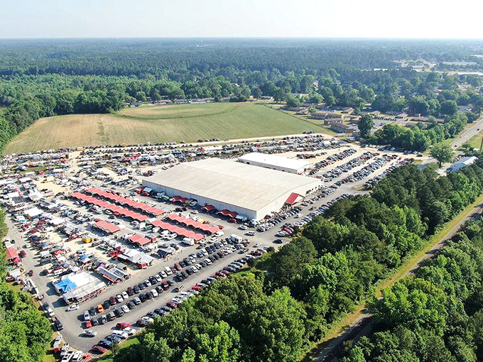From above, the scale becomes clear &ndash; cars fill the massive lot as shoppers flock to this retail phenomenon. A bargain-hunting metropolis.