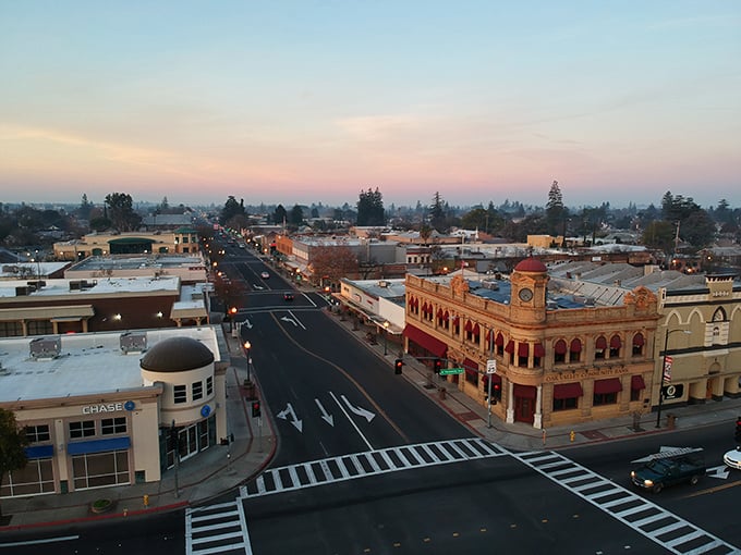 Sunset bathes downtown in golden light, revealing Oakdale's architectural character&mdash;where historic buildings aren't museum pieces but living, breathing businesses.