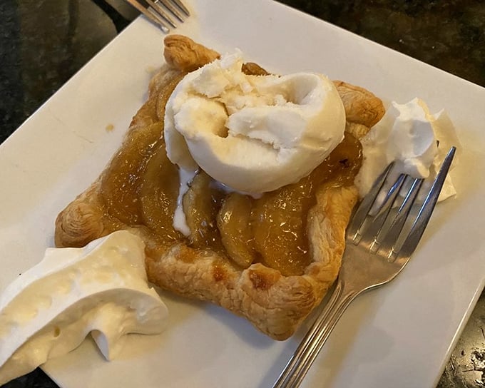 Hot apple tart with ice cream melting into warm, buttery pastry. The kind of dessert that makes you forget your own name.