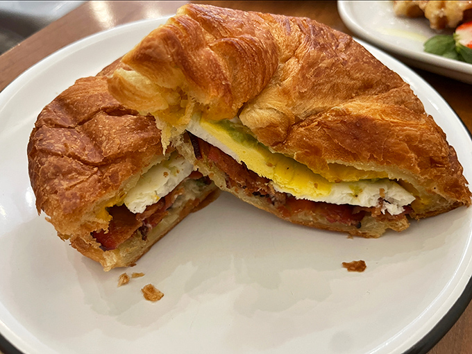 The breakfast sandwich in its final form &ndash; a croissant creation cut in half to reveal the architectural marvel of egg, bacon and cheese within.