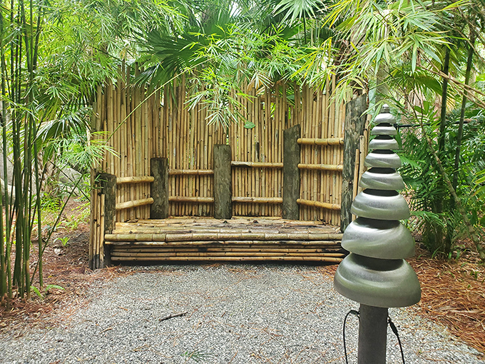 Bamboo serenity station with stone cairn companion. This thoughtful resting spot invites visitors to pause and breathe.