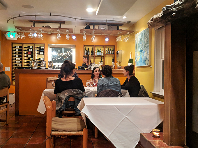 The bar area hums with anticipation as diners gather, knowing they're about to experience something that transcends ordinary restaurant fare.