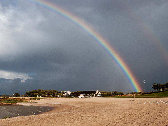 Nature's own fireworks display as a rainbow arcs over Erie Beach, proving that sometimes the pot of gold is simply being in the right place at the right time.