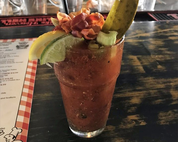 Not your average Bloody Mary! Topped with bacon, celery, pickle, and enough garnishes to count as a small meal, it's breakfast in a glass—Florida style.