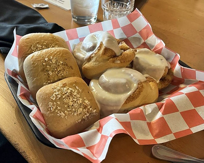 Fresh-baked rolls arrive like warm ambassadors from the kitchen. Half traditional, half cinnamon-swirled decadence&mdash;because sometimes you need options in your carb diplomacy. 