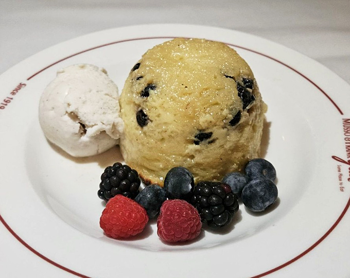 Bread pudding that would make your grandmother weep with joy, surrounded by berries that add bright notes to this sweet finale.