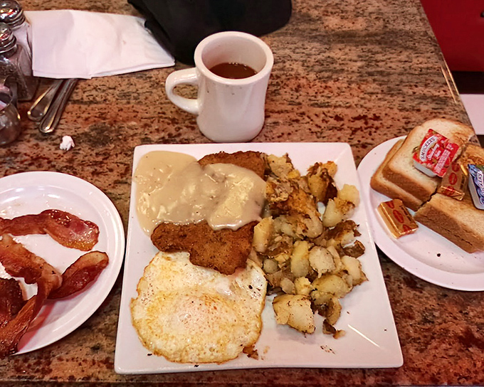 The classic American breakfast plate—where eggs, bacon, toast, and hash browns gather for their daily meeting of the Delicious Club.
