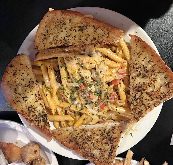 Buffalo chicken pasta that doesn't just sit on the plate&mdash;it performs. Those triangles of garlic bread stand ready to ensure not a drop of sauce goes unappreciated.