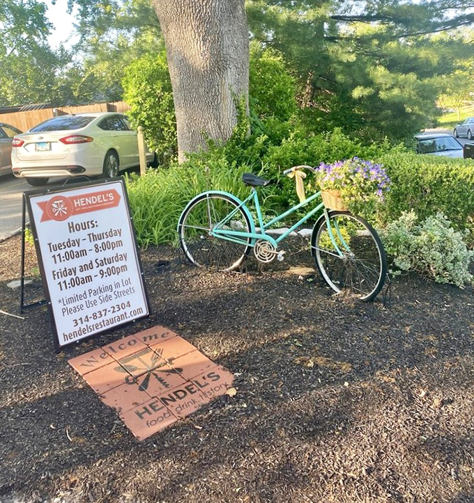 A vintage bicycle and welcome sign greet visitors like old friends, while business hours promise plenty of opportunities for culinary adventures.