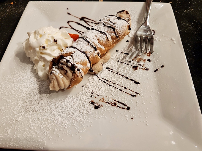 A cannoli that's powdered, drizzled, and ready for its close-up – the sweet finale that makes you immediately start planning your return visit.