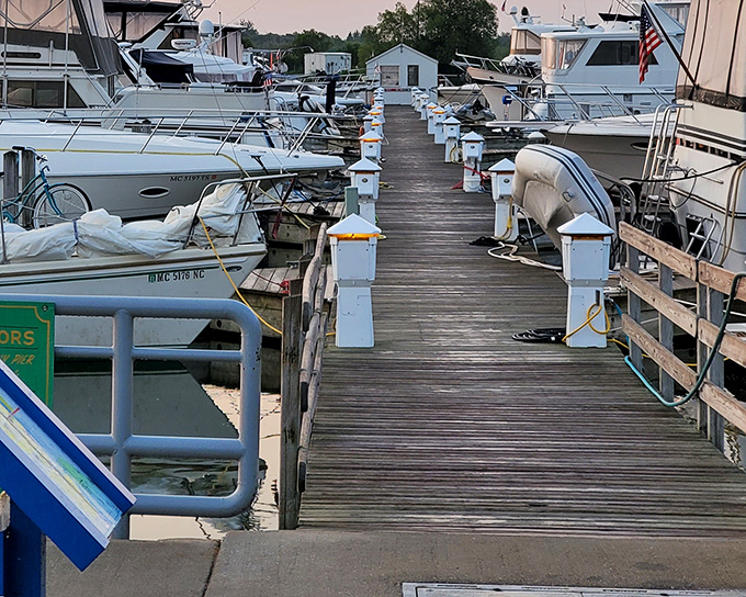 The marina's wooden walkways lead to adventures on Lake Huron, where boats stand ready for fishing expeditions or sunset cruises on Michigan's magnificent waters.