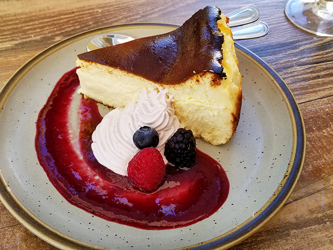 A slice of cheesecake that demands a moment of reverent silence. That berry sauce creates the perfect sweet-tart counterpoint to creamy decadence.