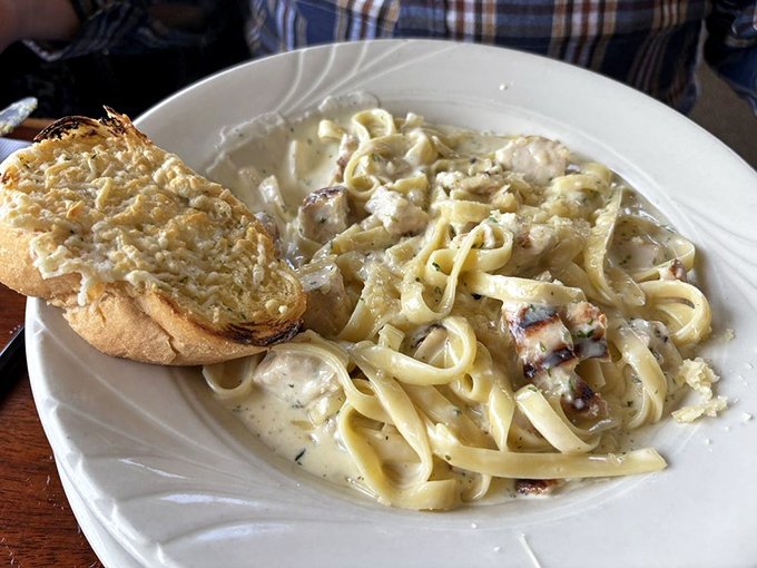 Fettuccine Alfredo with grilled chicken and garlic bread – comfort food that tastes even better with an ocean view.
