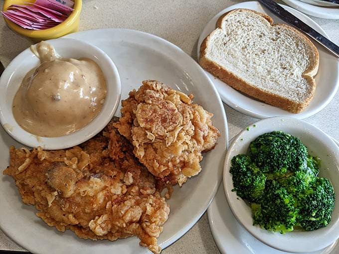 Fried chicken with mashed potatoes and gravy—proof that some comfort foods are worth every minute of the 30-minute prep time warning.