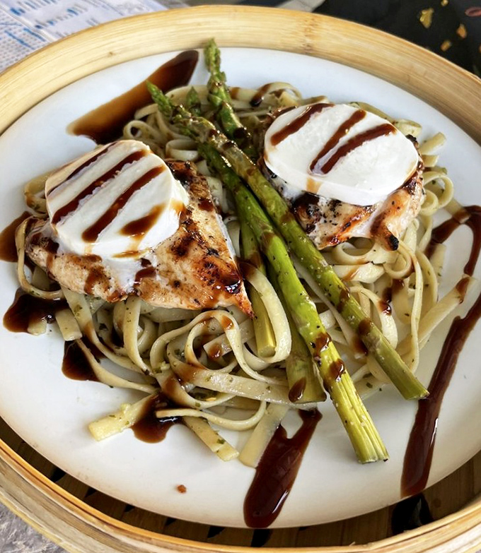 Chicken meets pasta in a symphony topped with asparagus spears that stand at attention like culinary soldiers.