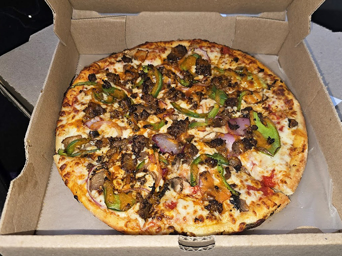 A meat lover's fantasy with colorful peppers providing just enough vegetable presence to pretend it's balanced. This is what happens when a pizza reaches its final form.