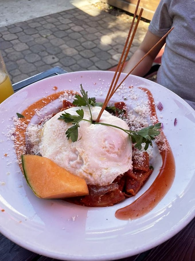 Chilaquiles that make you question why you ever settled for ordinary breakfast. That egg on top is basically wearing a sombrero of deliciousness.