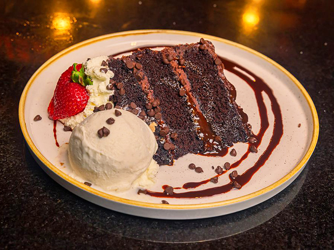Chocolate cake so decadent it should require a permission slip. That scoop of vanilla ice cream is providing essential diplomatic relations.