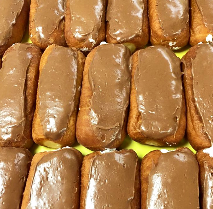 Chocolate long johns lined up like delicious dominoes. One bite and you'll understand why people set alarms before dawn to get here.