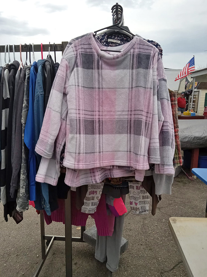 Cozy pink plaid fleece hangs among practical everyday wear &ndash; the perfect Virginia winter layer waiting for its new home.