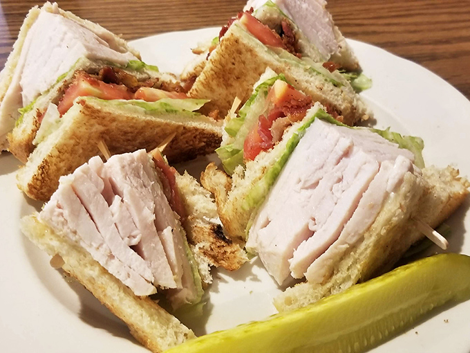 The club sandwich &ndash; America's most trustworthy lunch option. Triple-decker architecture that engineers would admire, with a pickle for perspective.