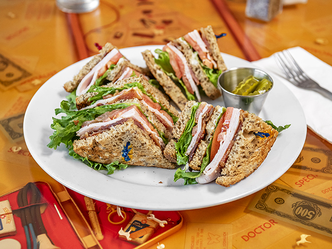 The club sandwich&mdash;architecture's greatest contribution to lunch. Layers of goodness held together by toothpicks and optimism, with pickles standing guard.