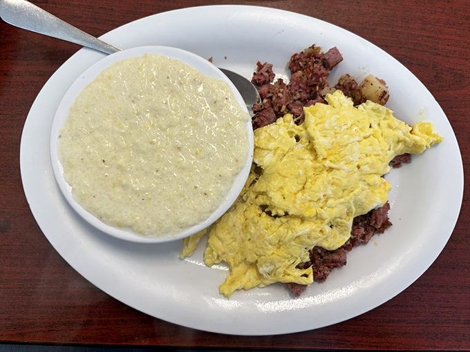 Corned beef hash with grits and eggs&mdash;a breakfast trinity that proves heaven exists and it's on this very plate.