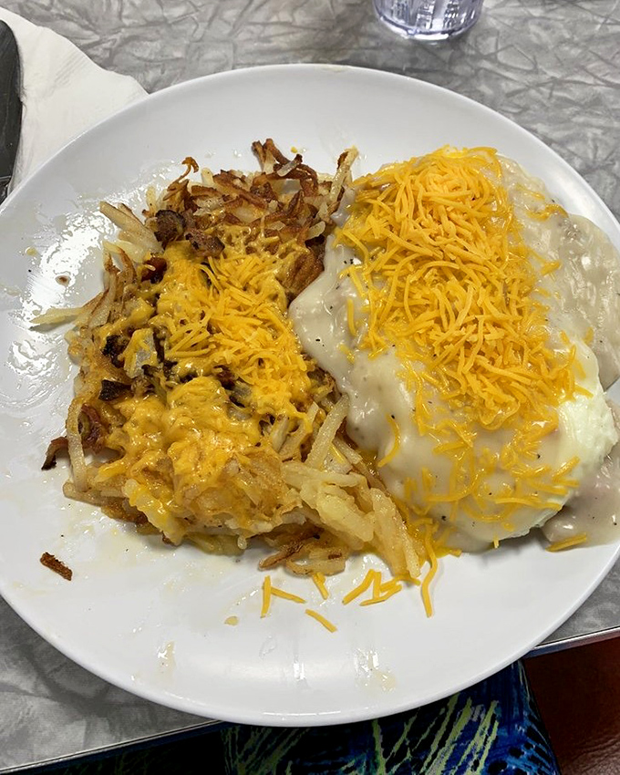 Country biscuits smothered in gravy with a blanket of melted cheese. Not just breakfast—it's a warm hug on a plate that says "good morning" in comfort-food language.
