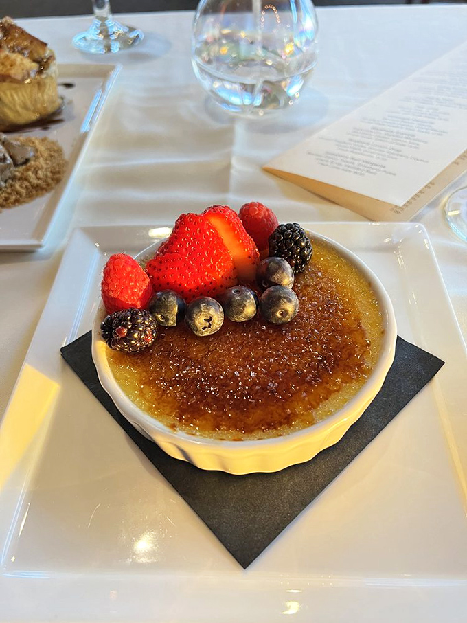 Cr&egrave;me br&ucirc;l&eacute;e with fresh berries&mdash;because after all that seafood, your sweet tooth deserves its moment in the spotlight too.
